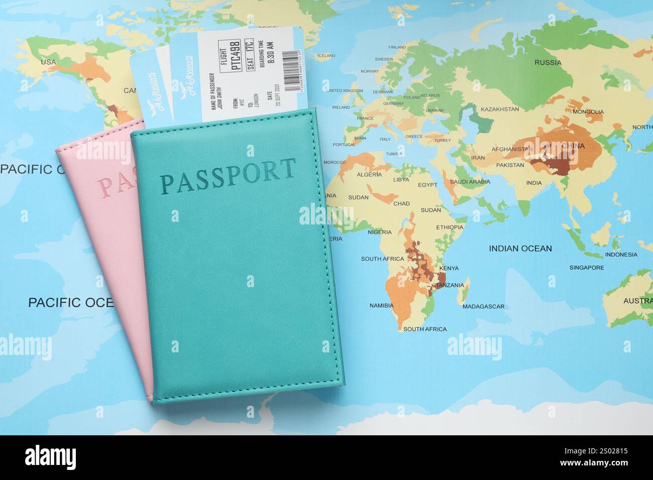 Travel agency. Flight tickets and passports on world map, flat lay ...
