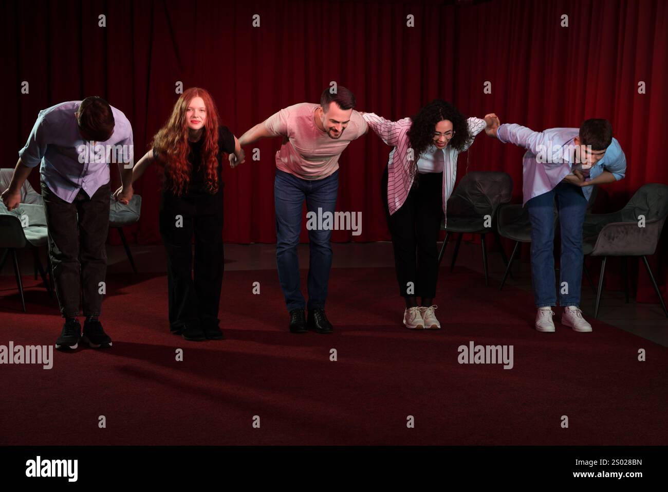 Professional actors bowing on stage in theatre Stock Photo - Alamy