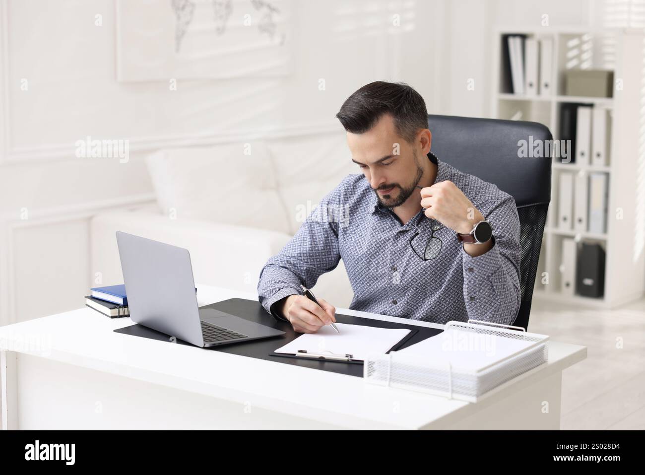 Handsome banker signing document hi-res stock photography and images ...