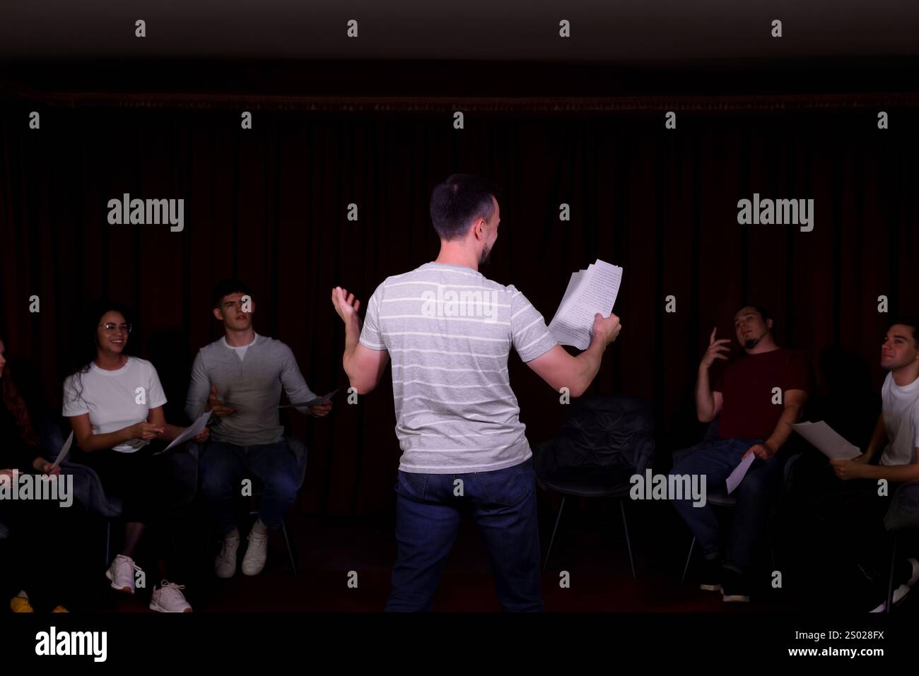 Professional actors with their scripts rehearsing in theatre Stock ...