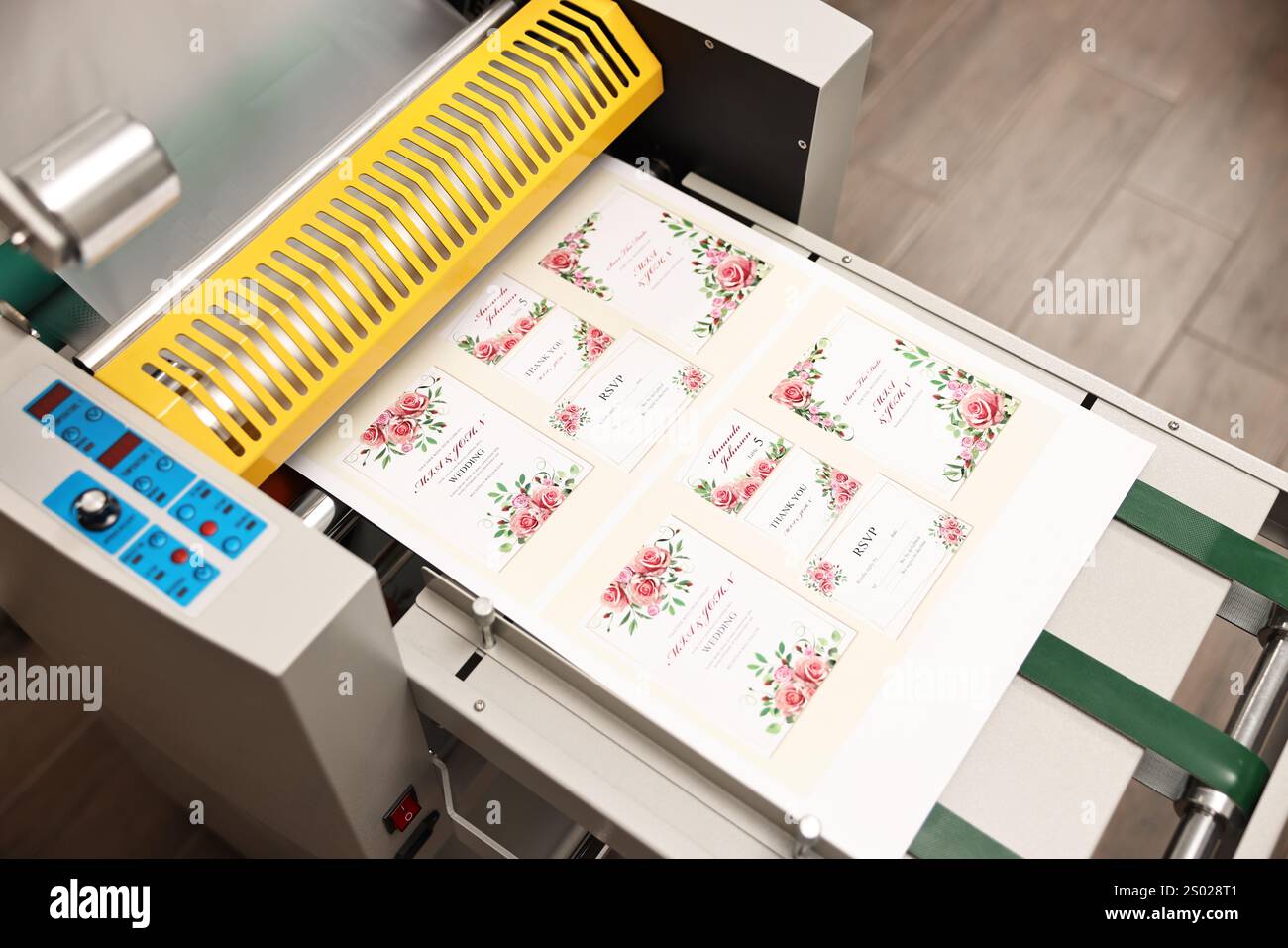 Modern roll laminator and paper sheet with invitation cards indoors ...
