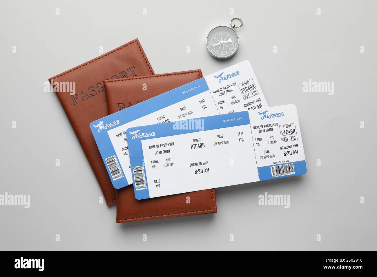 Travel agency. Flight tickets, passports and compass on grey background ...