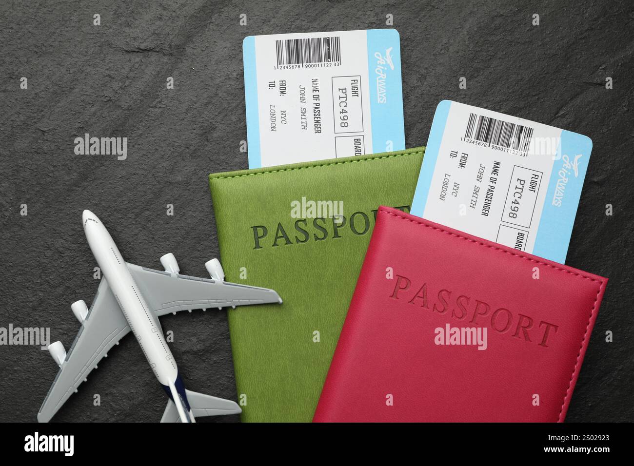 Travel agency. Flight tickets, passports and plane model on dark ...