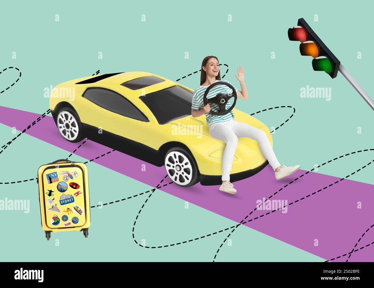Happy driver with steering wheel on toy car, traffic light and suitcase ...