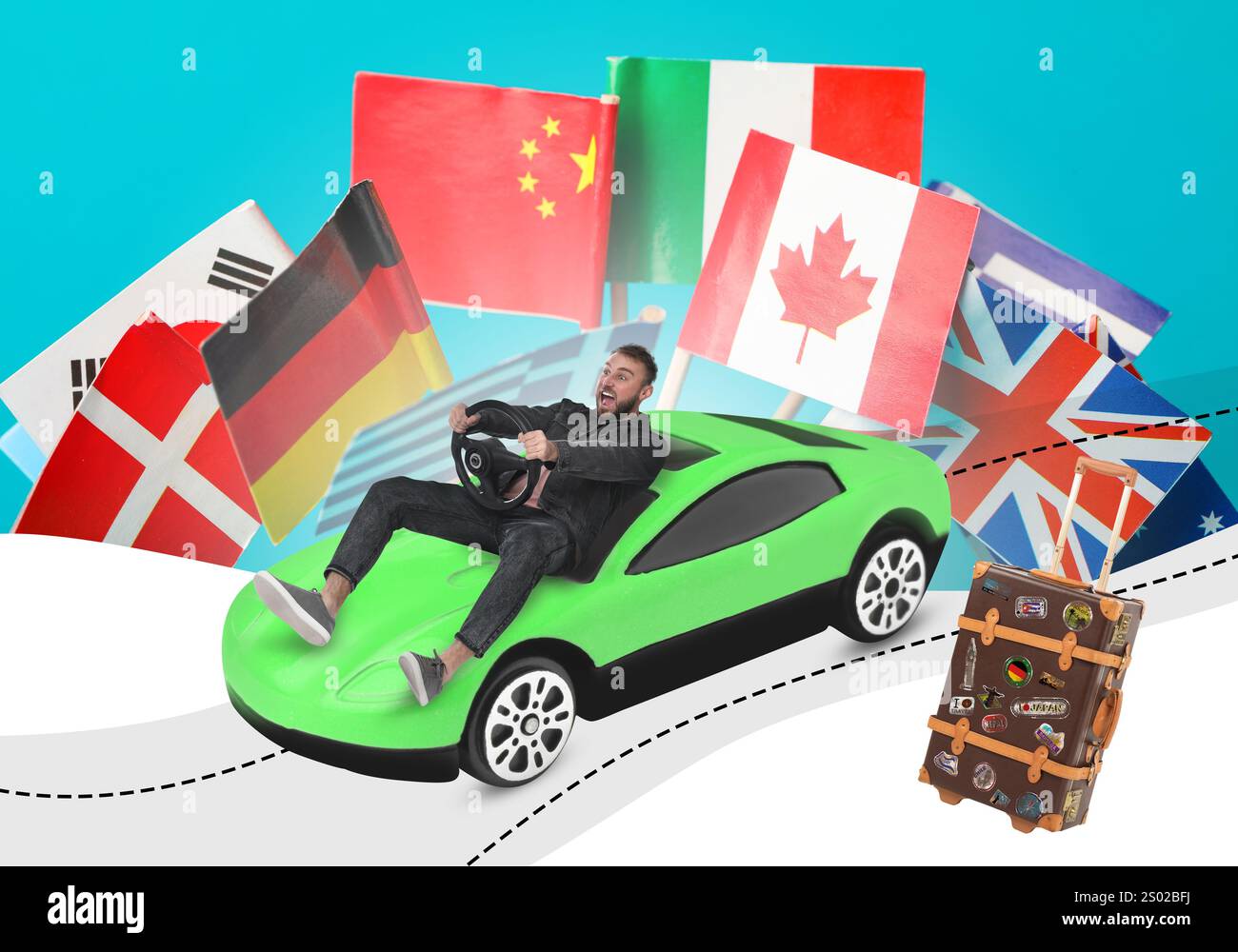 Emotional driver with steering wheel on toy car against flags of ...