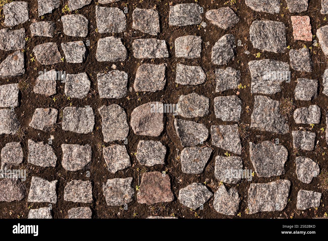 Paving stones with uneven cracks, weathered appearance. background ...