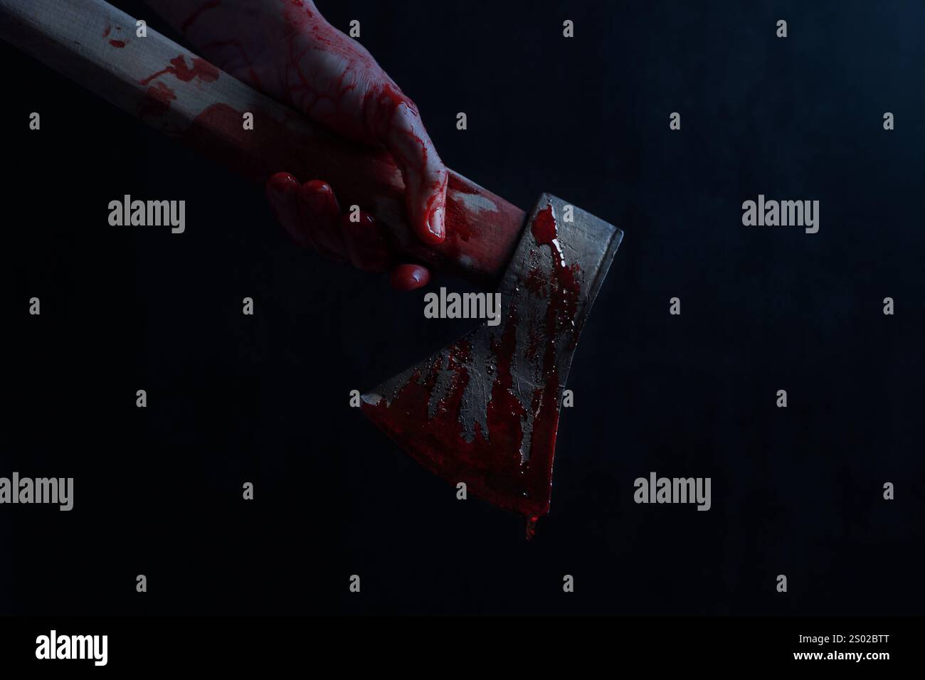 Man holding bloody axe in darkness, closeup Stock Photo - Alamy