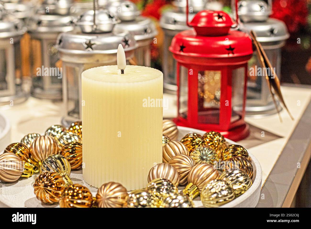 decorative candle with small golden balls at the bottom Stock Photo - Alamy