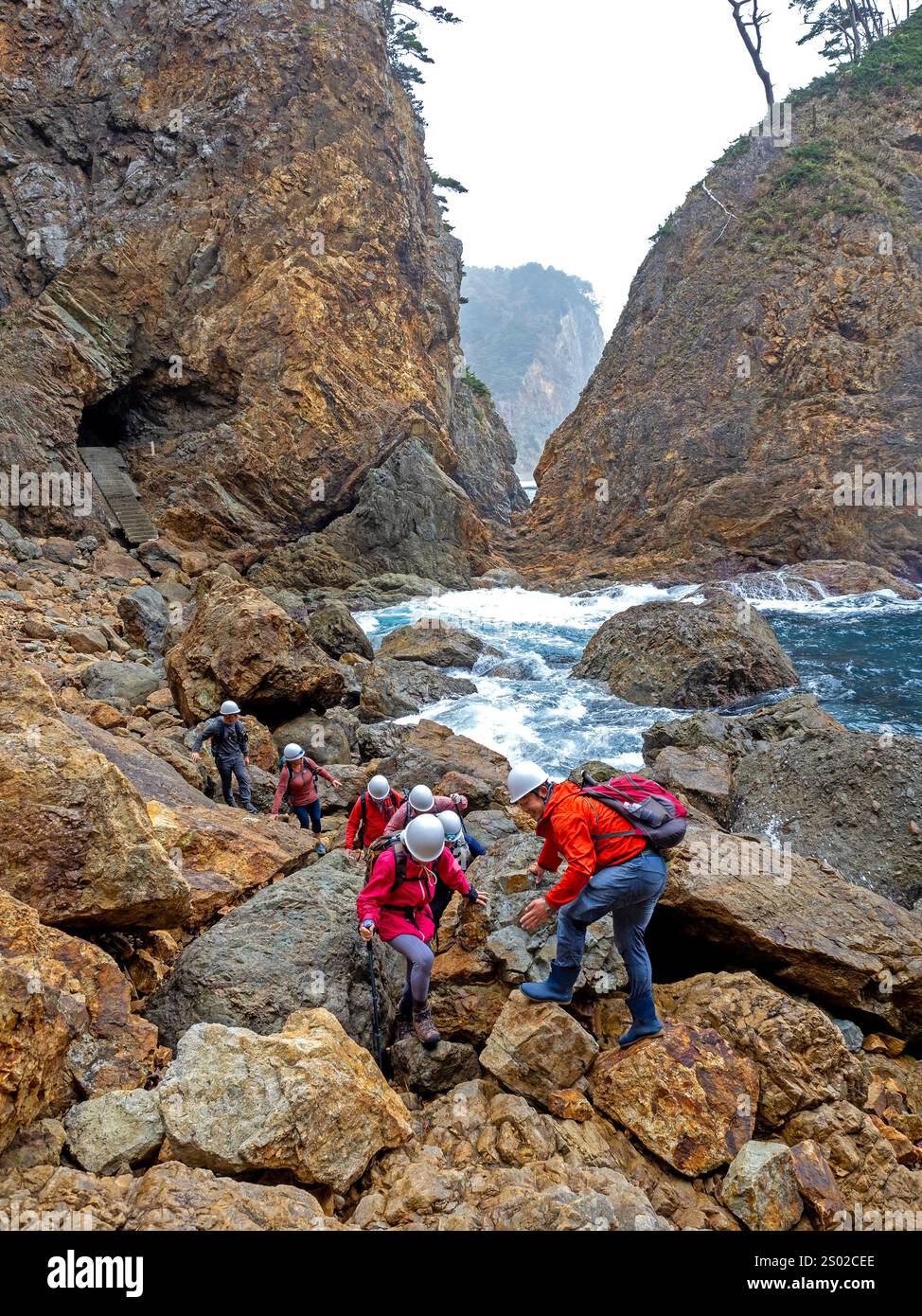 Hikers below the Kitayamazaki Cliffs on the Michinoku Coastal Trail ...