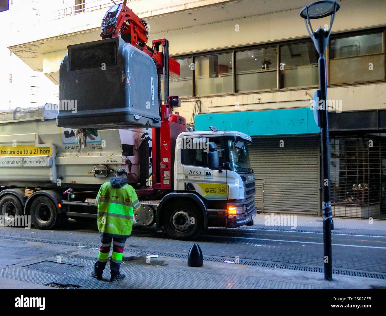 Garbage collection truck with waste container lifting arm with ...