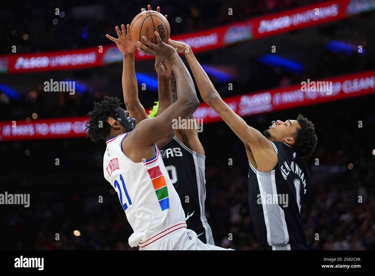 Philadelphia 76ers' Joel Embiid, left, tries to get a shot past San ...