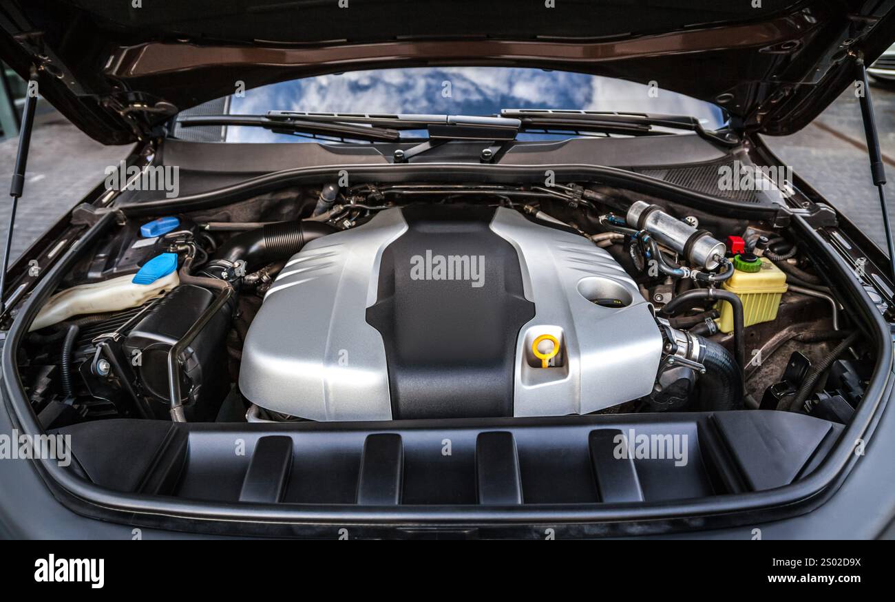 A close-up view of a modern car engine under the hood, showcasing the ...