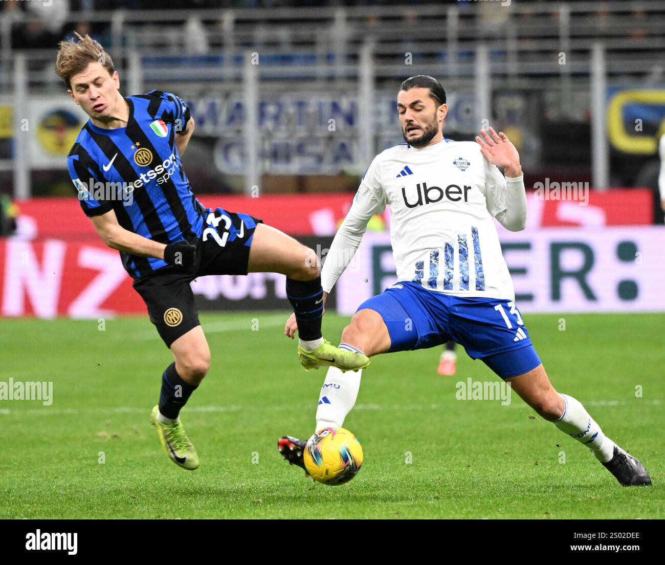Milan, Italy. 23rd Dec, 2024. Inter Milan's Nicolo Barella (L) vies ...