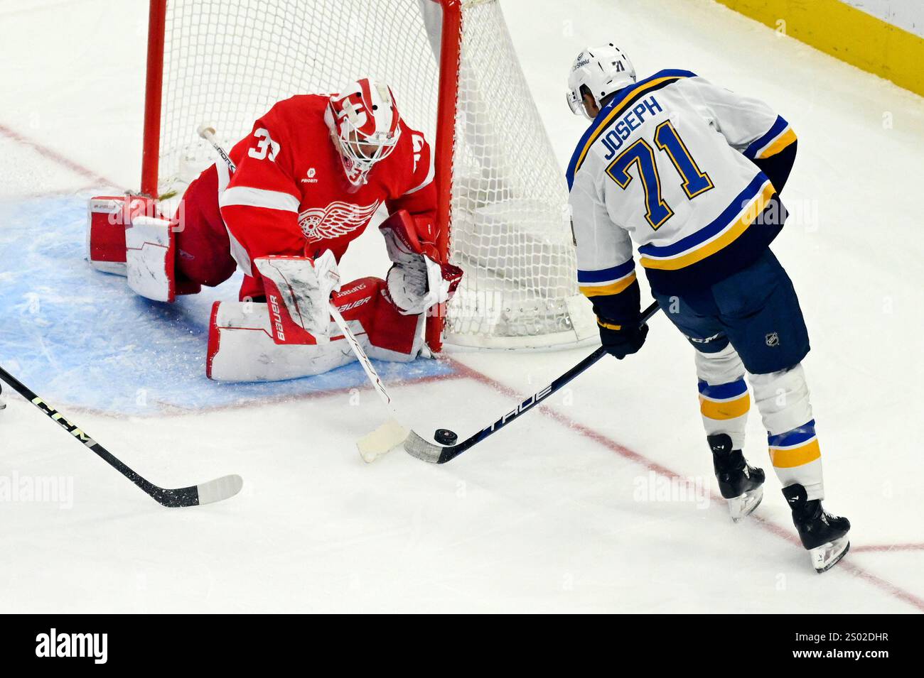 Detroit Red Wings goaltender Cam Talbot, left, knocks the puck away ...