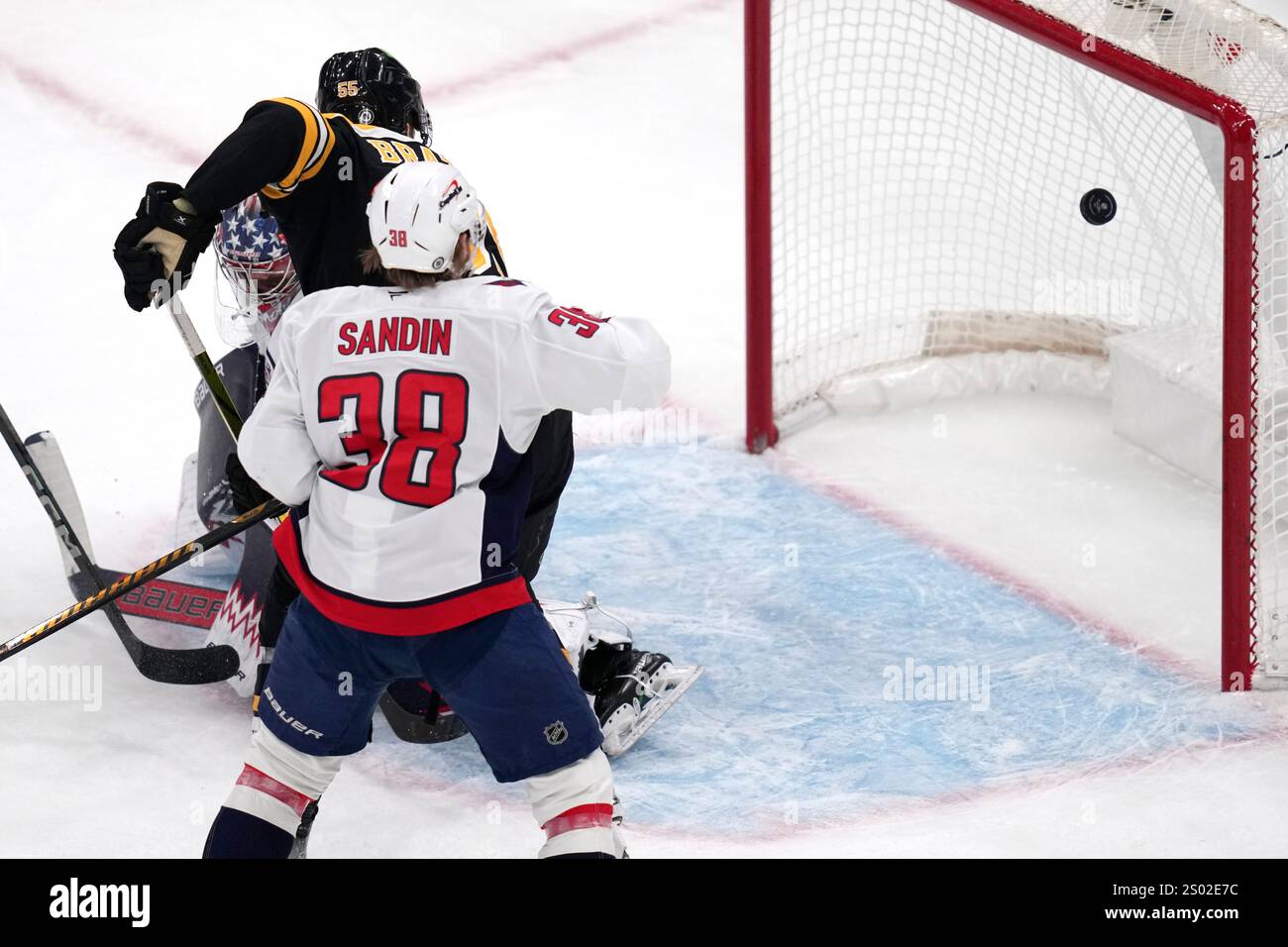 Boston Bruins right wing Justin Brazeau, left, back hands a shot for a ...