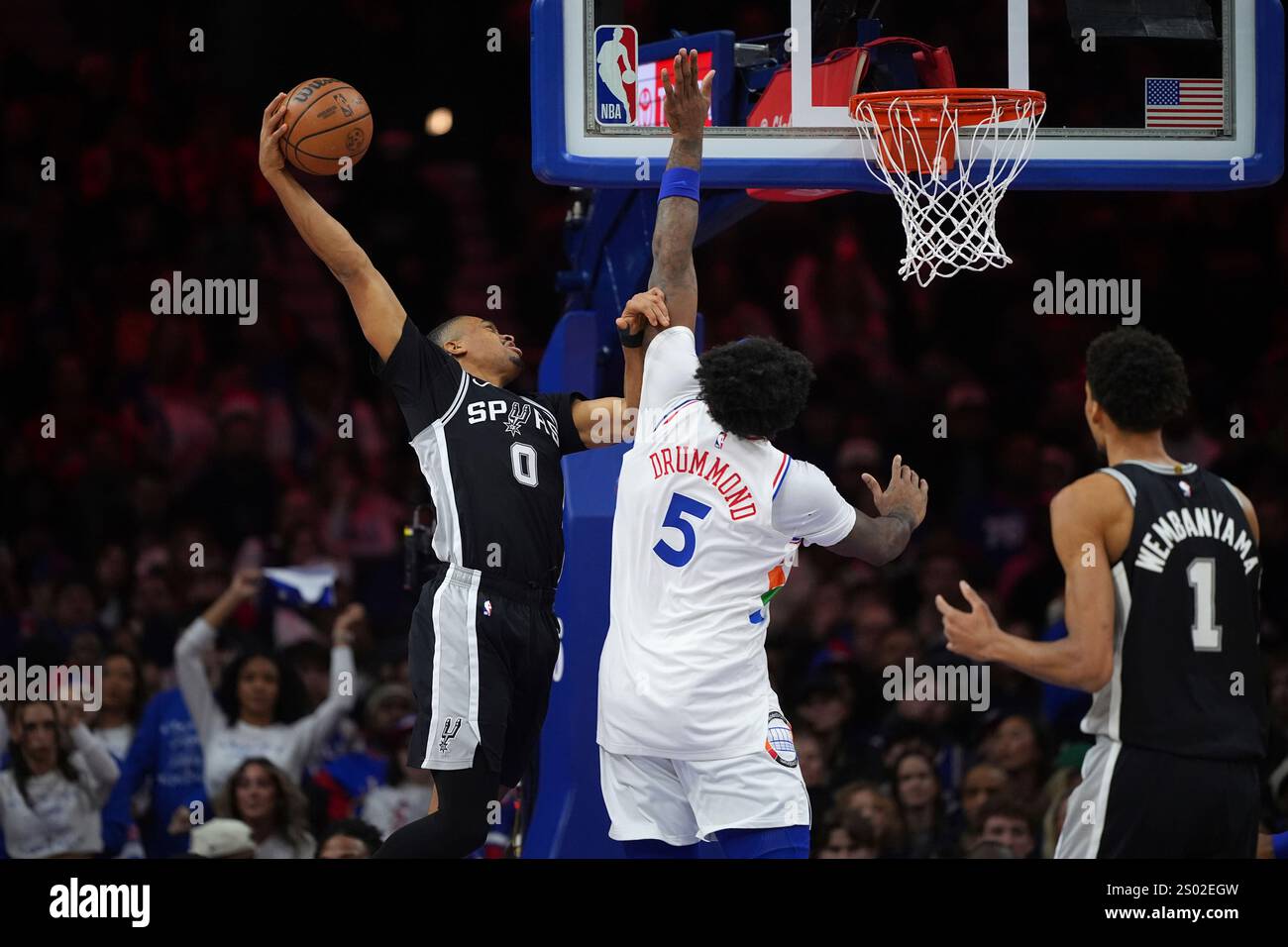 San Antonio Spurs' Keldon Johnson, left, goes up for a dunk against ...