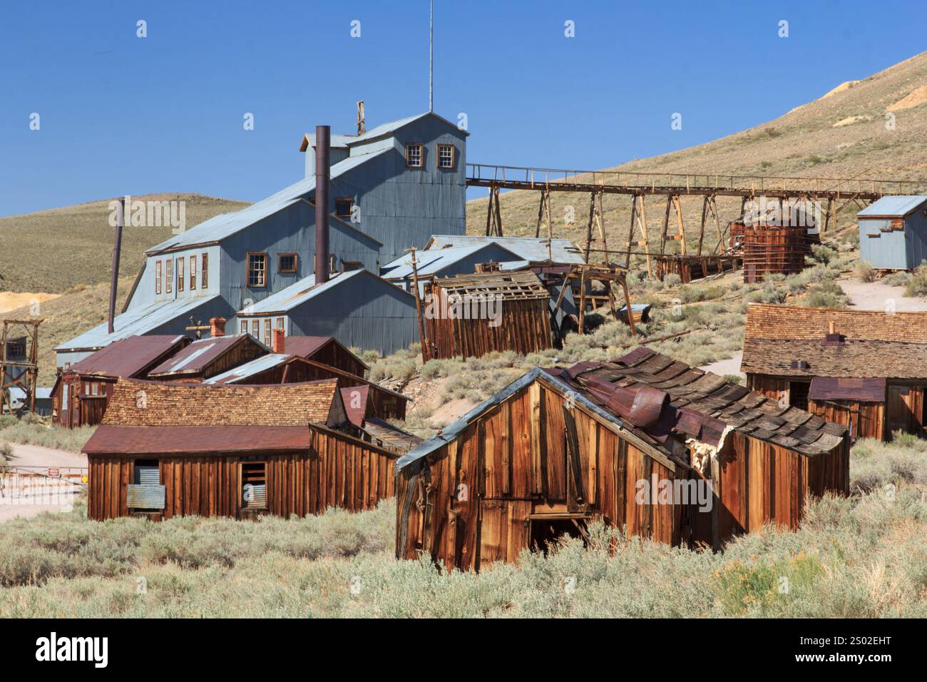 A small town with a few old buildings and a large, rusted, old building ...