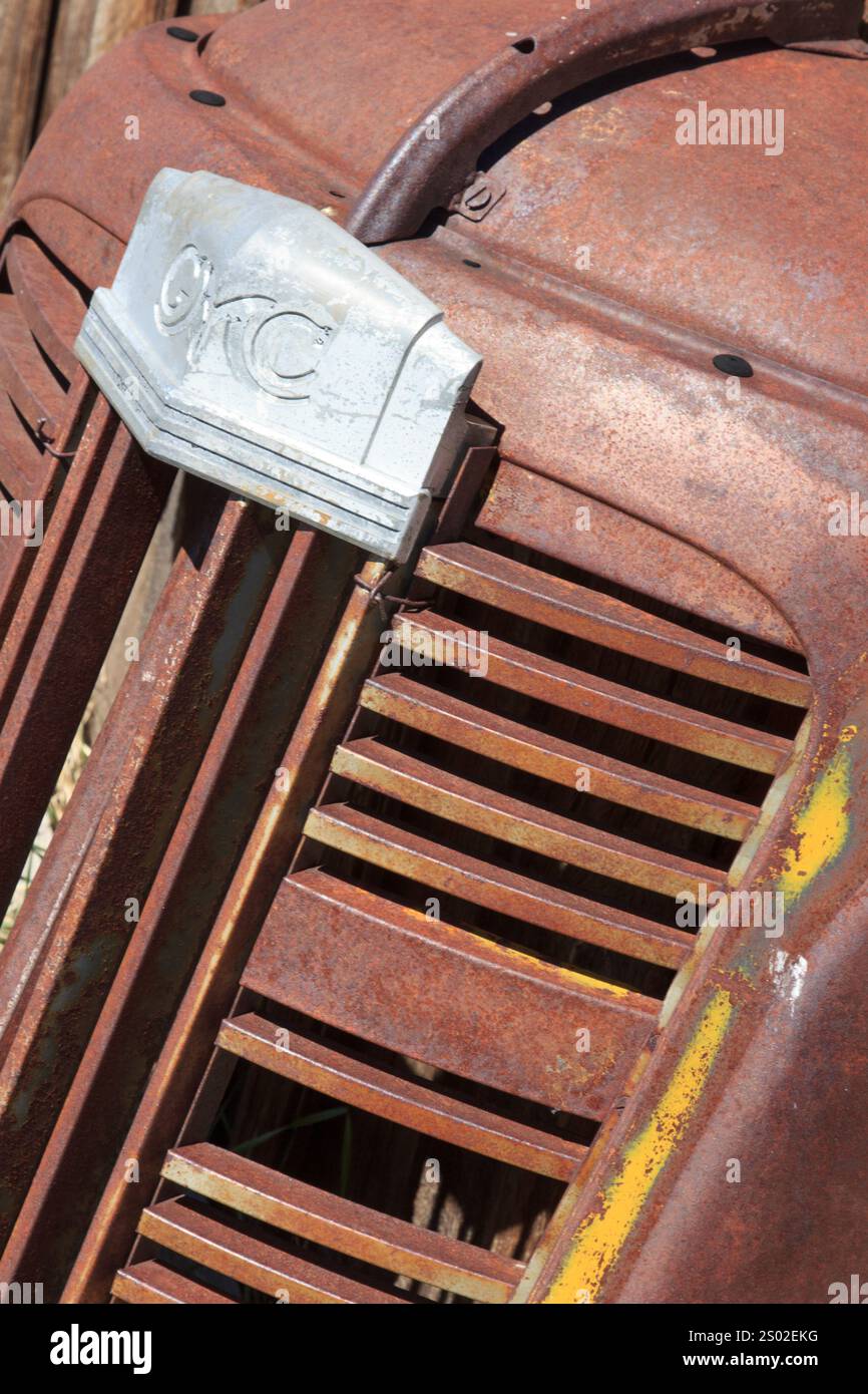 A rusty old truck hood with the letters KC on it. The hood is old and ...