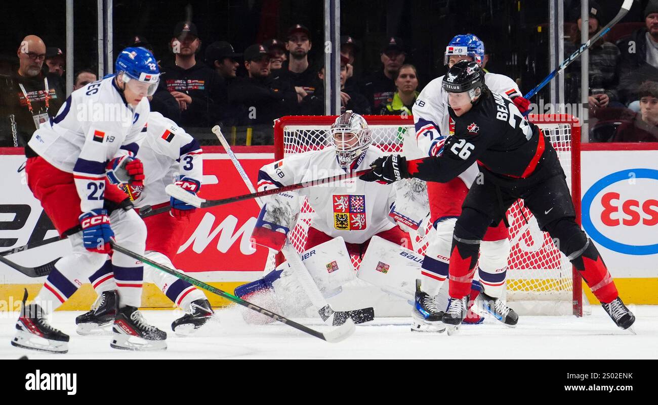 Canada's Cole Beaudoin (26) reaches to deflect a shot as Czechia's ...