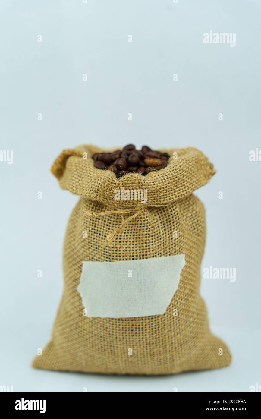 Burlap sack tightly filled with roasted coffee beans, featuring a blank ...
