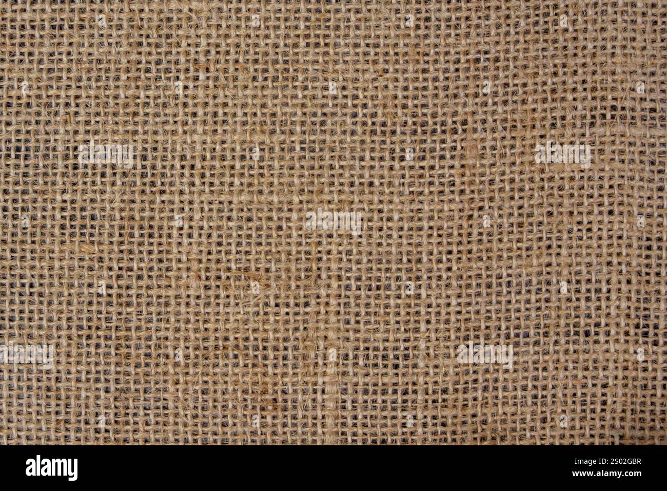 Close-up view of a burlap fabric showing its woven texture and rustic look, ideal as a natural ...