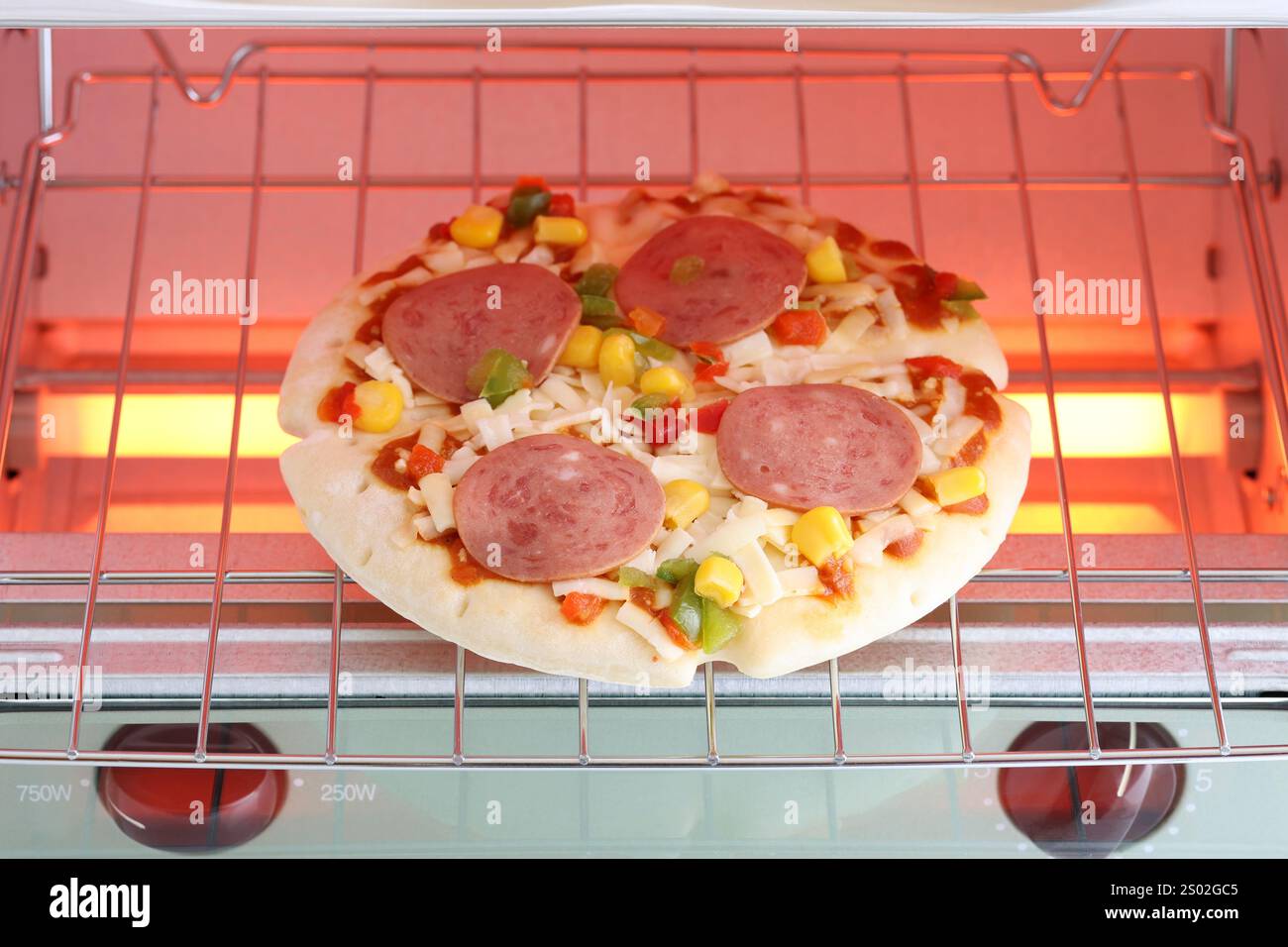 Close up of a frozen pizza reheated in the electric oven Stock Photo ...