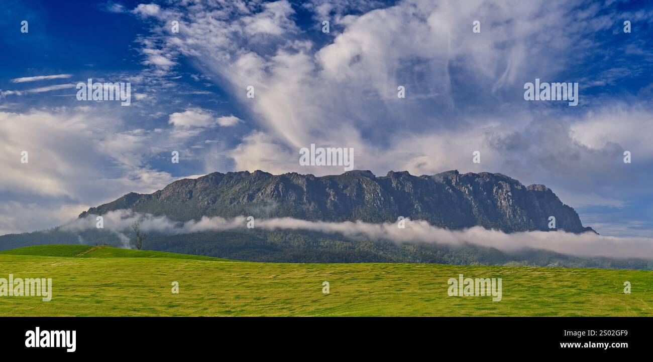 View of monolith Mount Roland range with morning light fog and mist ...