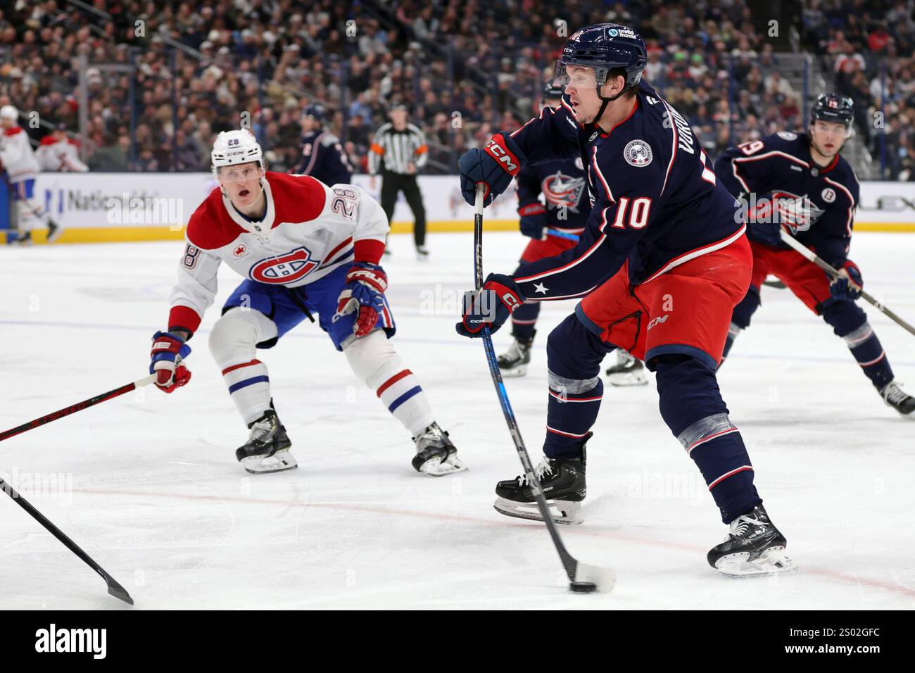 Columbus Blue Jackets forward Dmitri Voronkov, right, shoots the puck ...