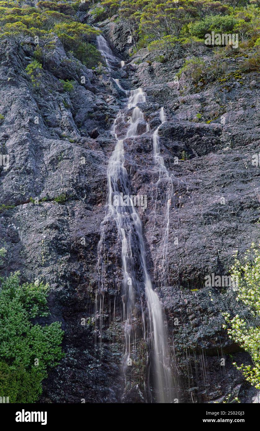 Reggie's falls, a thin small ephemeral waterfall cascade over dark rock ...