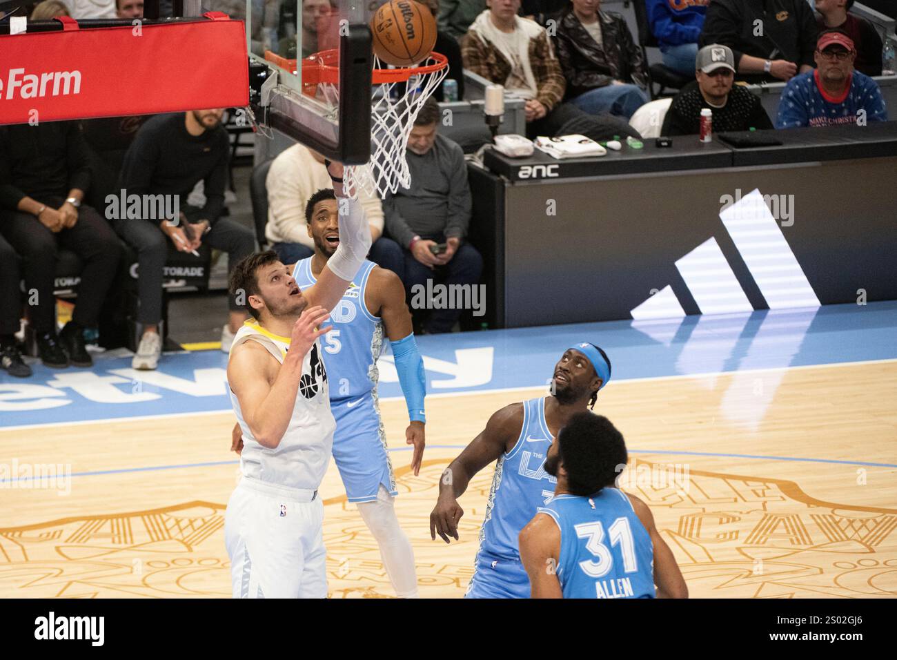 Utah Jazz's Walker Kessler, left, shoots as Cleveland Cavaliers ...