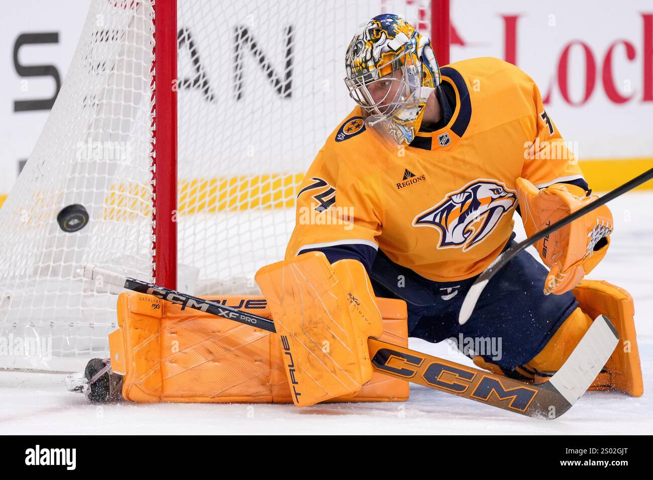 Nashville Predators goaltender Juuse Saros (74) deflects a shot on goal ...