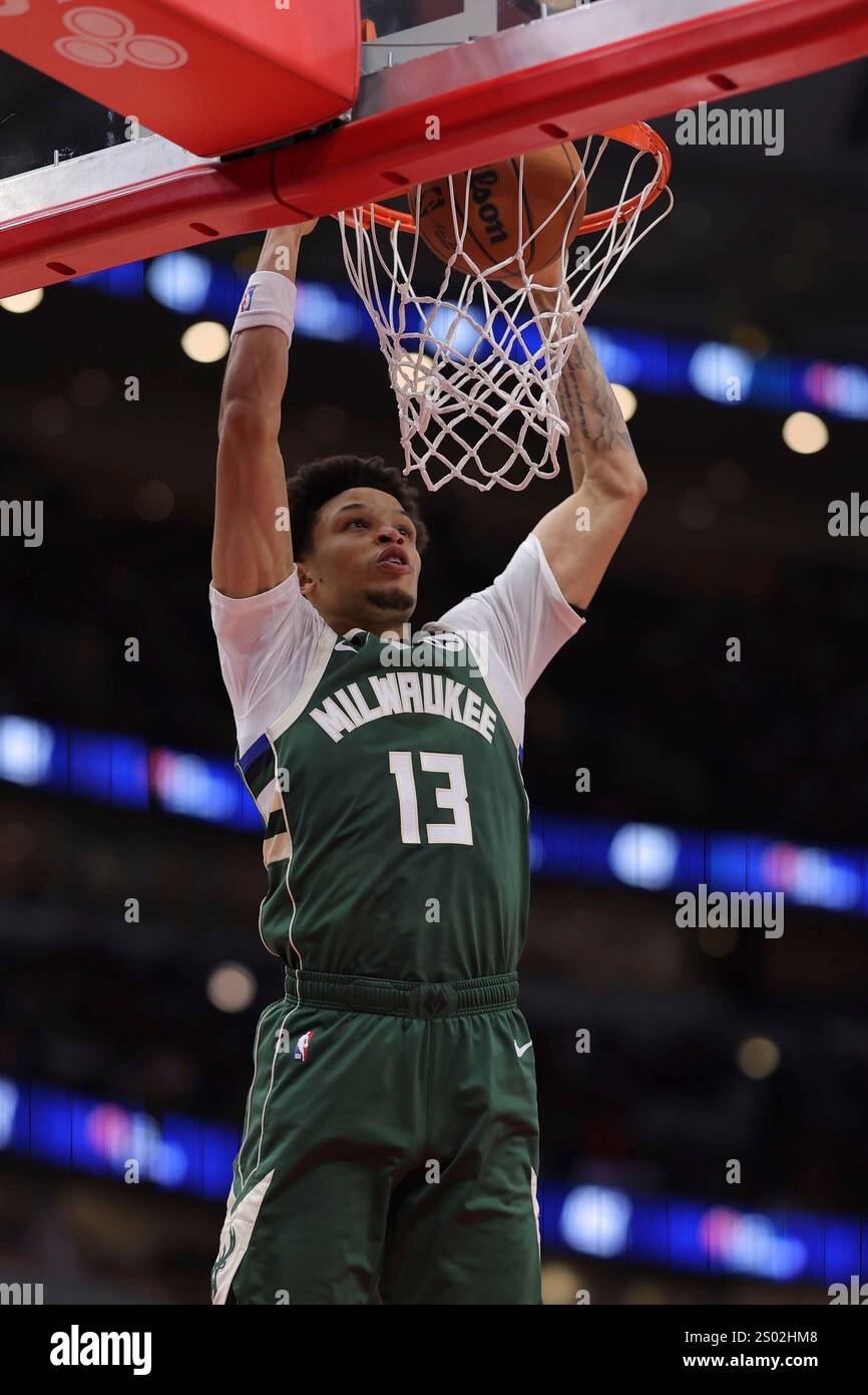 Milwaukee Bucks guard Ryan Rollins slam-dunks during the first half of ...