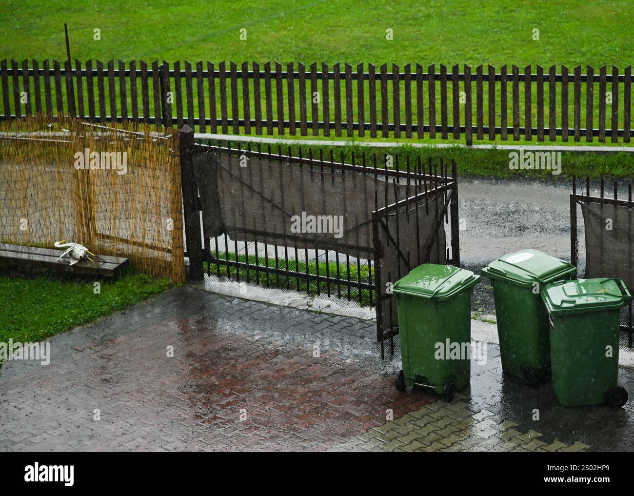 The plastic trash cans were soaked from the rain. The concept Stock ...