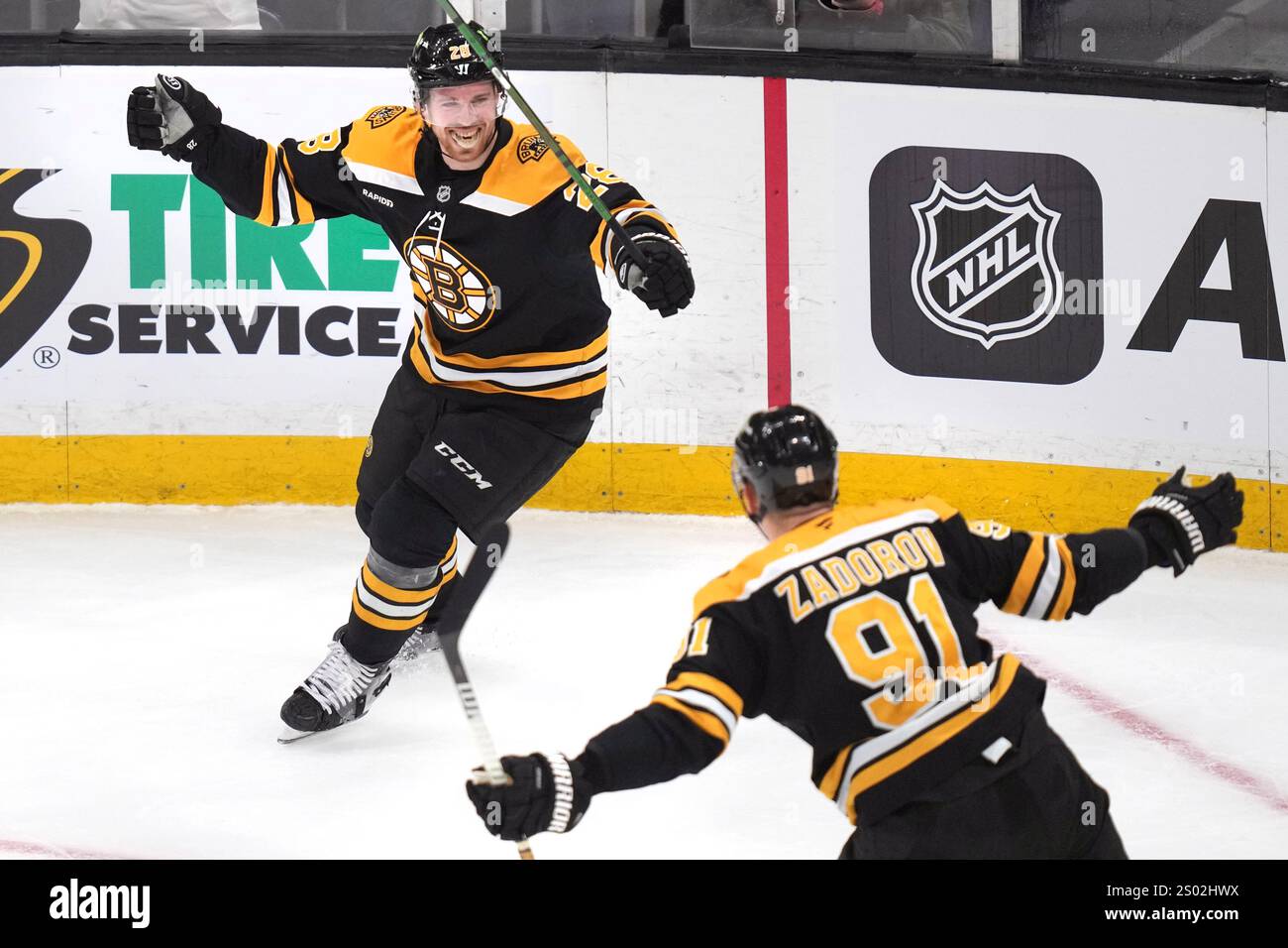 Boston Bruins center Elias Lindholm, left, celebrates after his goal ...