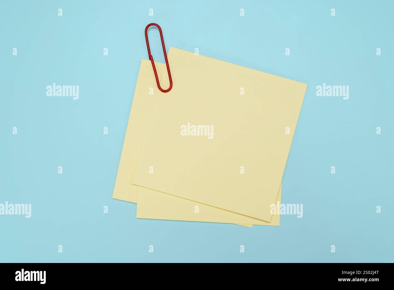 Blank post it note with green paper clip isolated on blue. Sticky notes ...