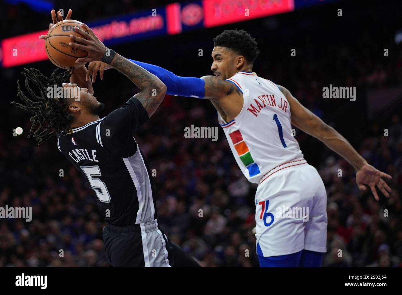 San Antonio Spurs' Stephon Castle, left, tries to get a shot past ...