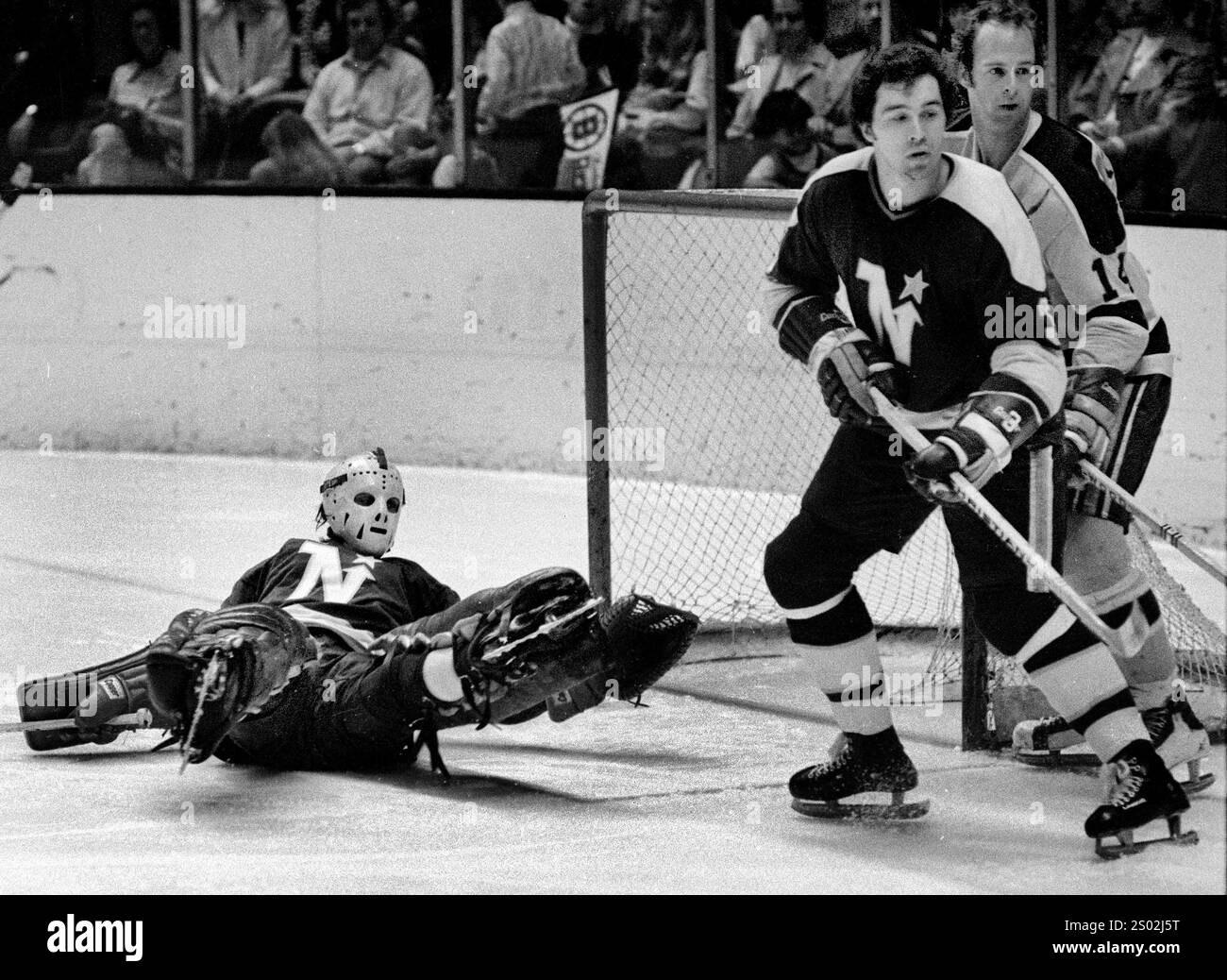 Minnesota NorthStars goalie Gilles Gilbert and Fred Barrett (3) defend ...