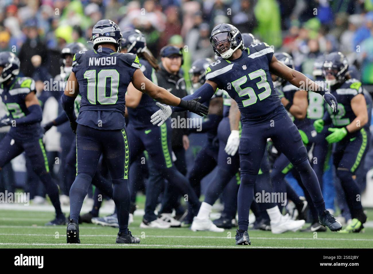 Seattle Seahawks linebacker Boye Mafe (53) greets linebacker Uchenna ...