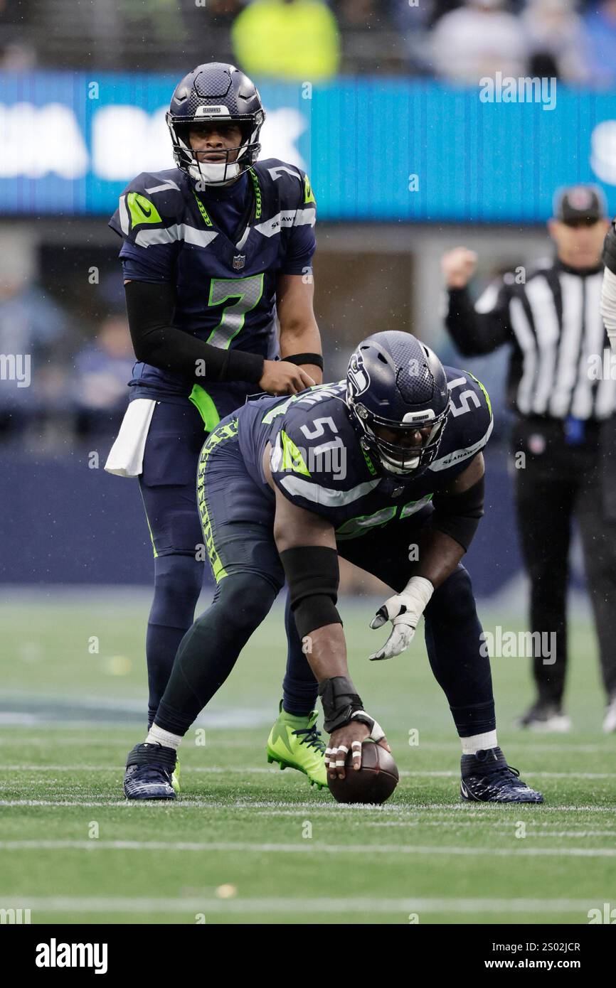 Seattle Seahawks quarterback Geno Smith (7) lines up behind center Olu ...