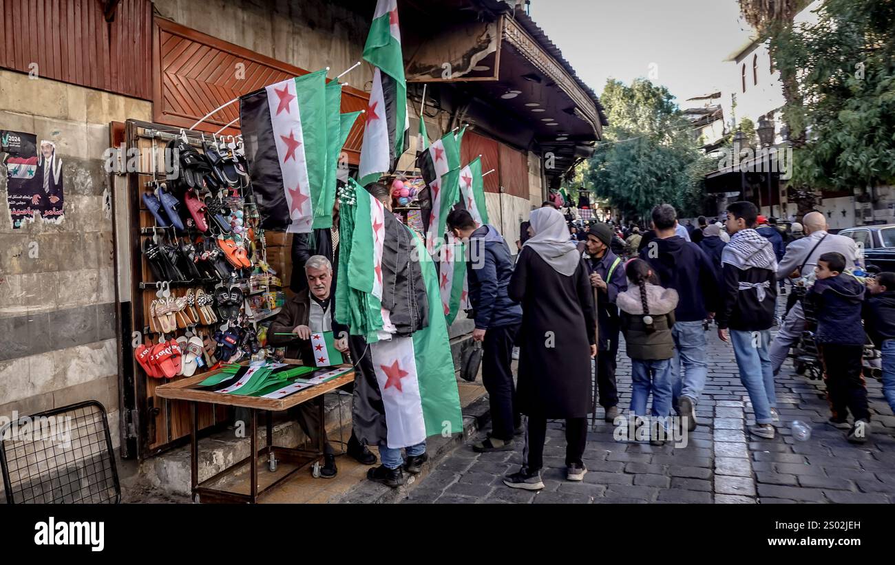 Hama, Syria. 13th Dec, 2024. Revolutionary flags on sale in Damascus ...