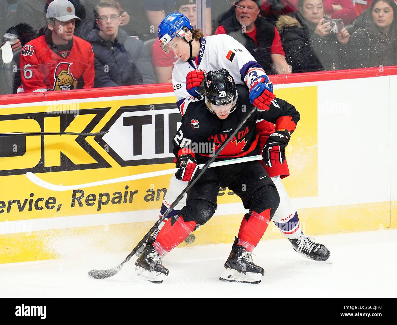 Czechia's Vojtech Port (3) vies with Canada's Ethan Gauthier (20) for ...