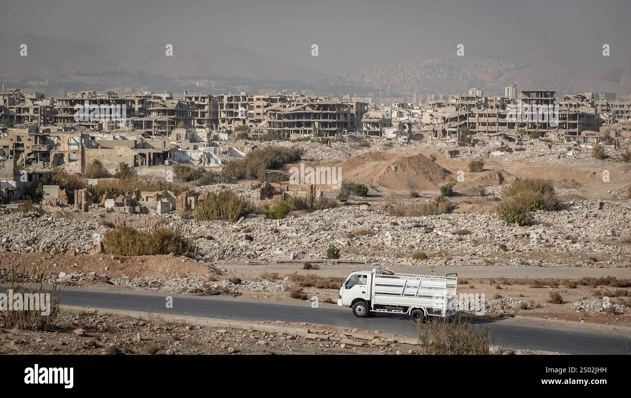 Hama, Syria. 12th Dec, 2024. A truck drives past Jobar on the outskirts ...