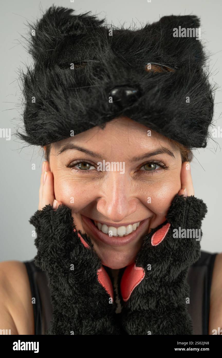 Portrait of a woman in a cat costume on a white background. Quadrober ...