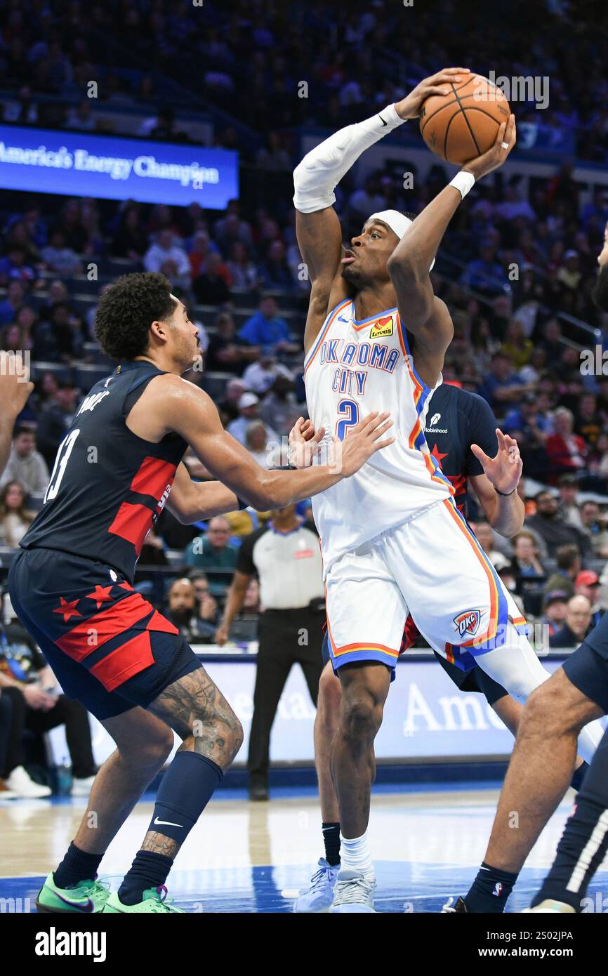 Oklahoma City Thunder guard Shai Gilgeous-Alexander, right, looks to shoot over Washington ...