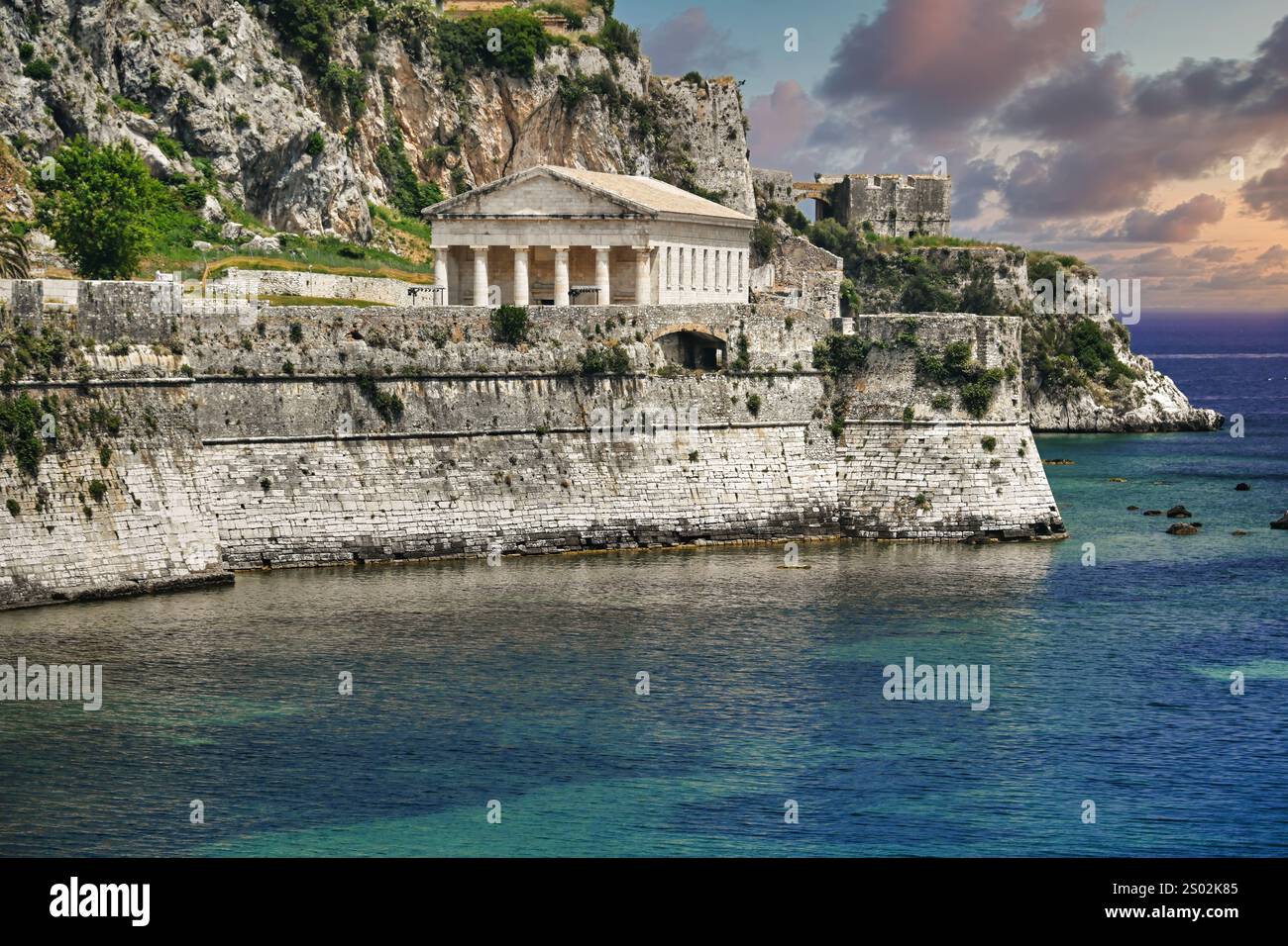 A historic seaside fortress stands proudly with a classical temple ...