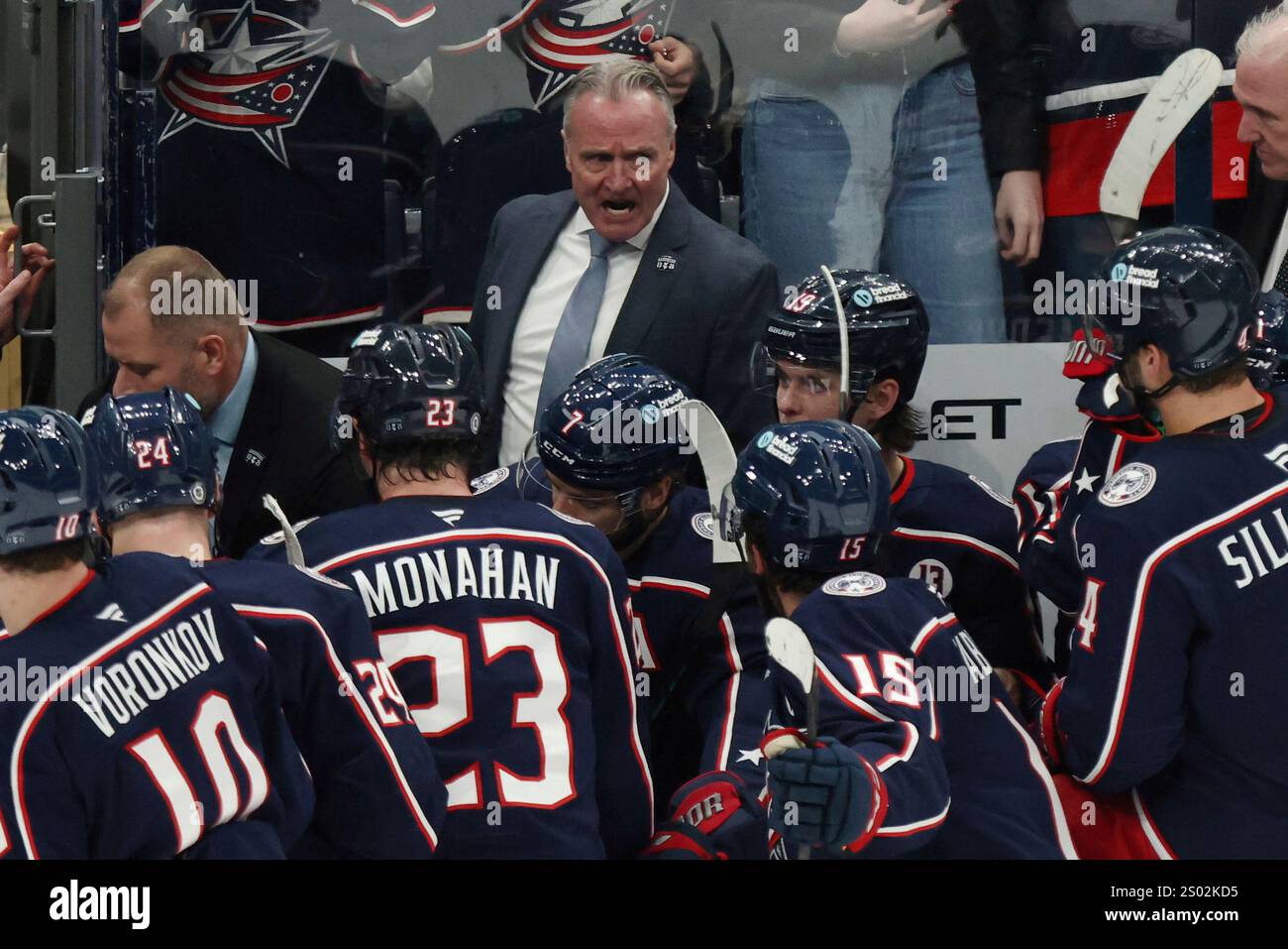 Columbus Blue Jackets coach Dean Evason, center to, talks to his team ...