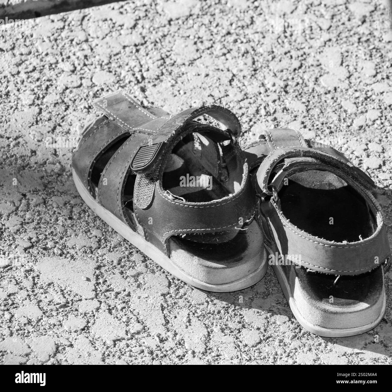 Small child's sandals outside black and white Stock Photo - Alamy
