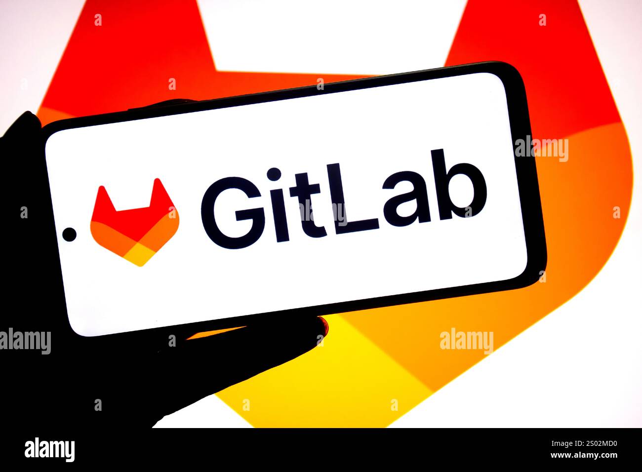 India. 17th Dec, 2024. In this photo illustration, a Gitlab logo is seen displayed on a ...