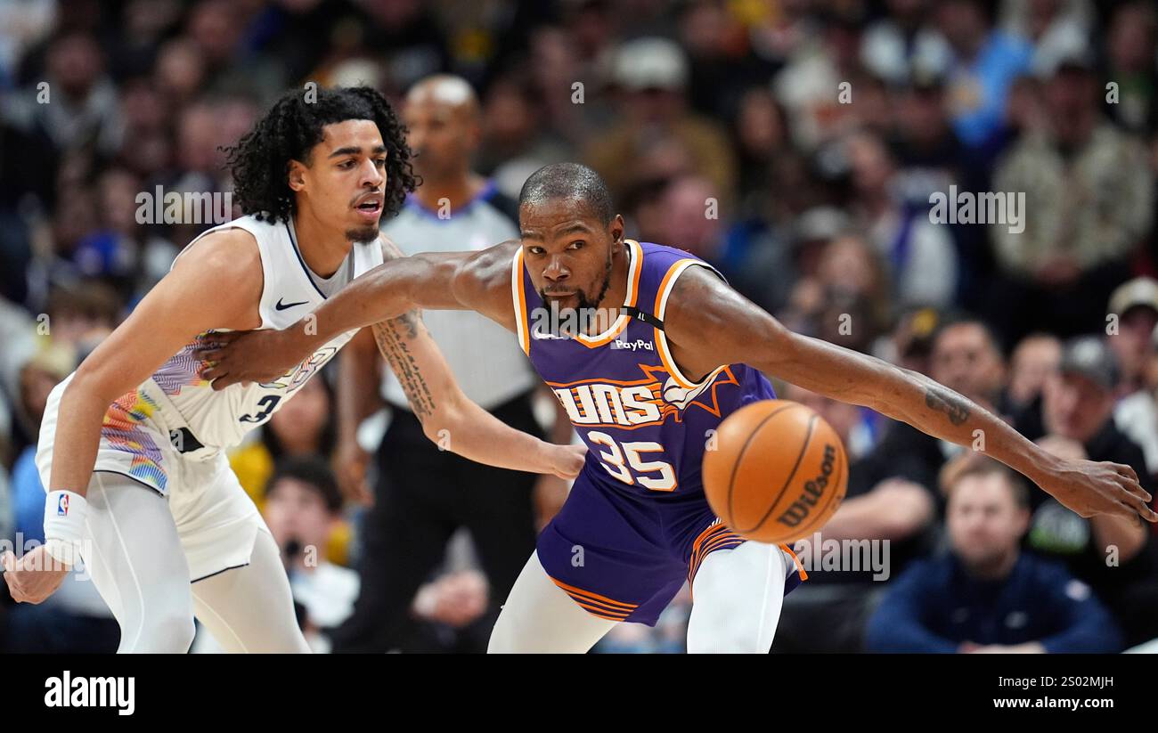 Phoenix Suns forward Kevin Durant, right, pursues the ball with Denver ...