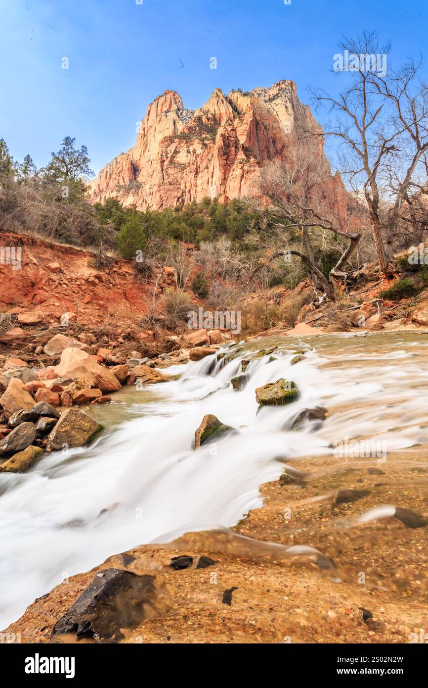 A river flows through a canyon with a mountain in the background. The ...